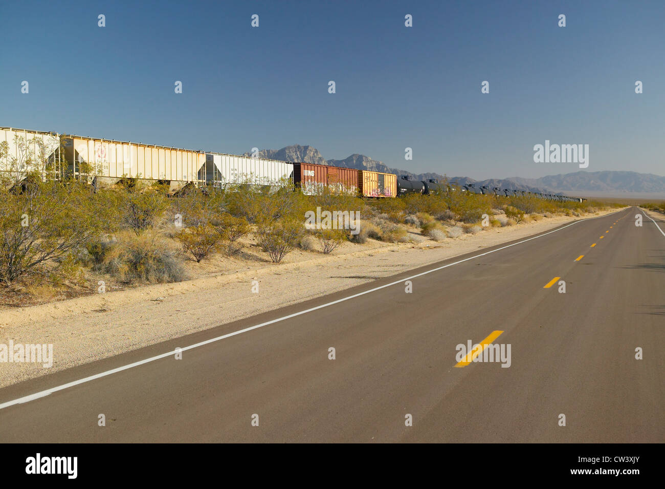 Freight train travels through desert and mountainous areas of Mojave ...