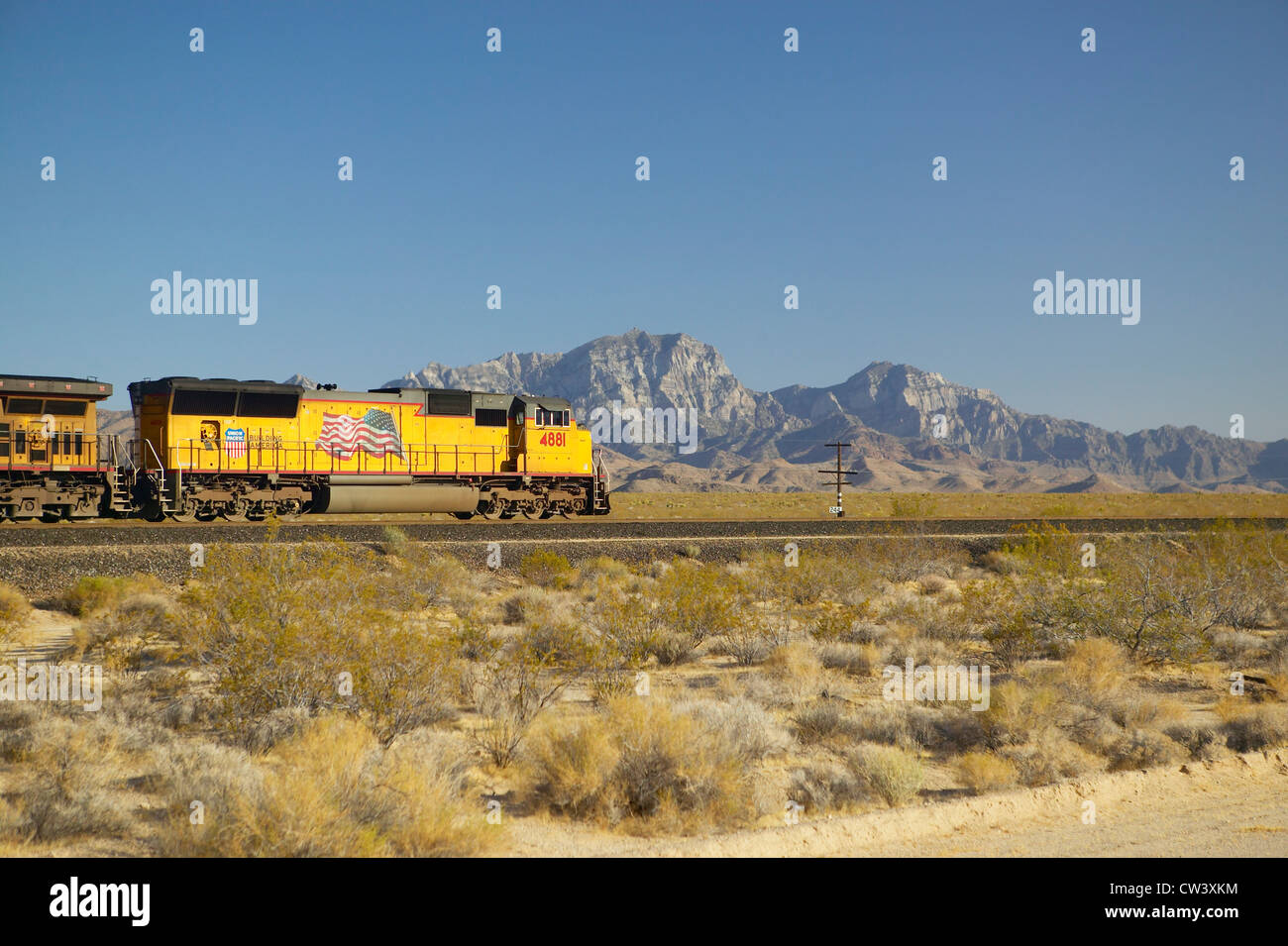 Freight train travels through desert and mountainous areas of Mojave ...