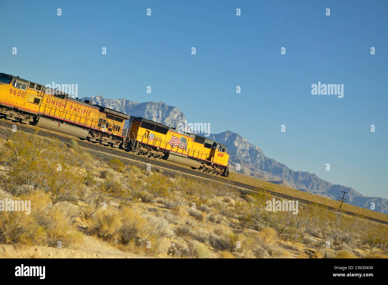Freight train travels through desert and mountainous areas of Mojave ...