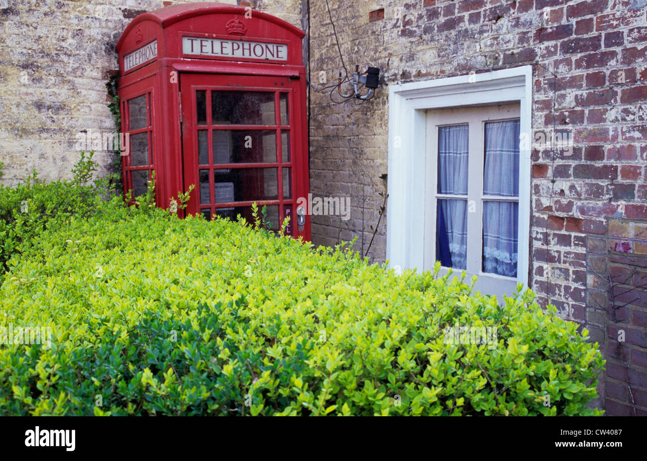 UK England Norfolk Old-fashioned British red telephone box squeezed in ...
