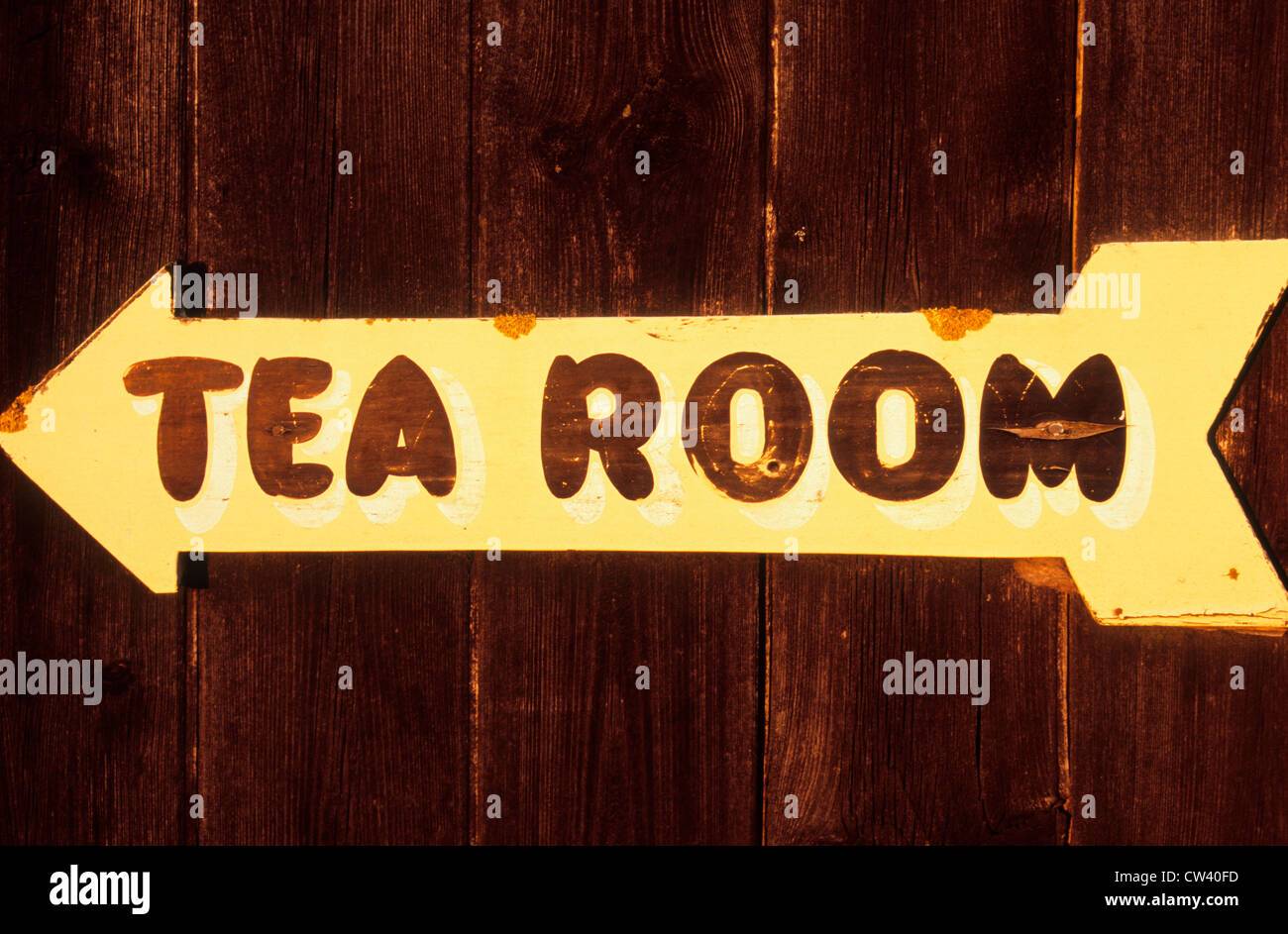 Tea room arrow sign painted on brown wall, Suffolk, England Stock Photo ...
