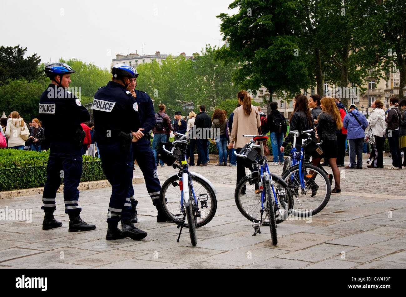 Parisian French police with bicycles at Sacre Coeur watching tourists ...