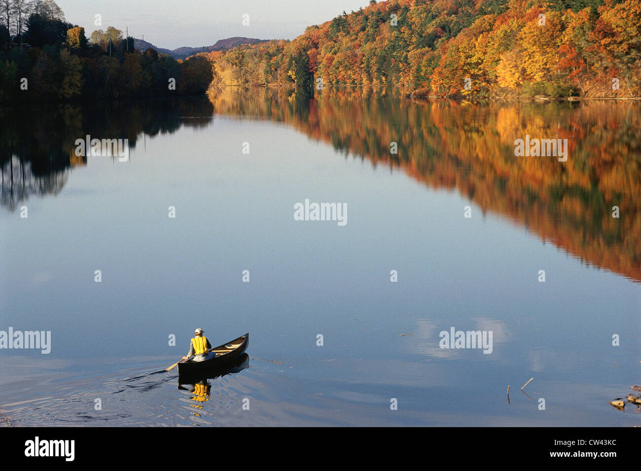 Man in boat on stream Stock Photo - Alamy