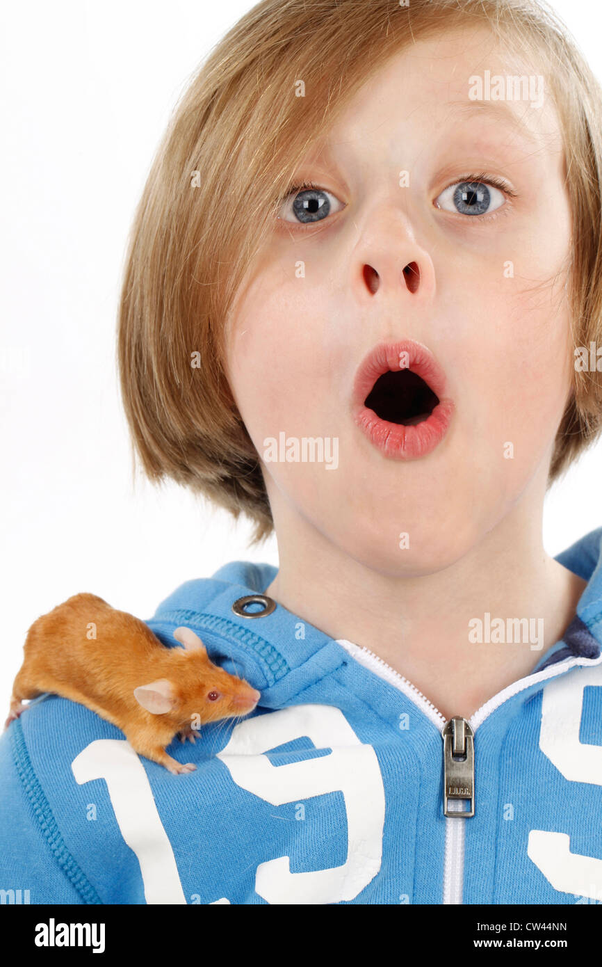 Astonished child with a Fancy Mouse on its shoulder. Studio picture ...