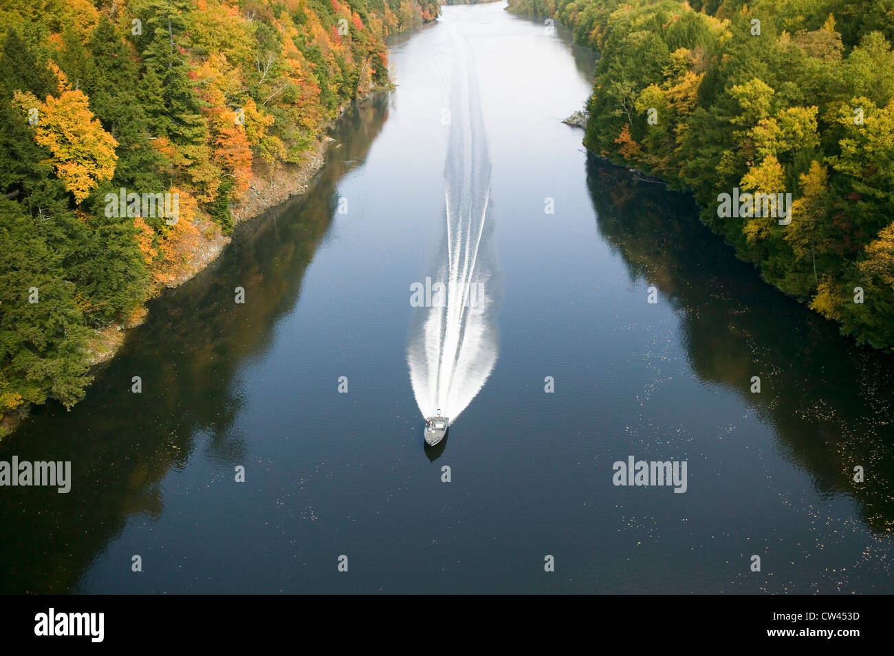 A boat navigates the Connecticut River through autumn color on the ...