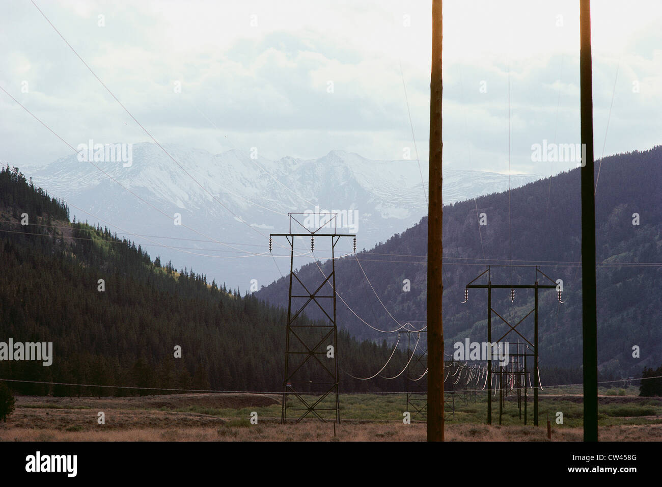 Pylons against mountain backdrop Stock Photo - Alamy