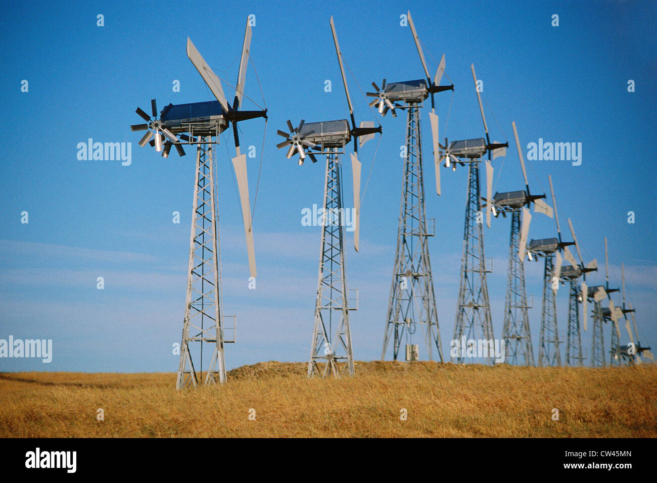 Row of wind turbines on ground Stock Photo - Alamy
