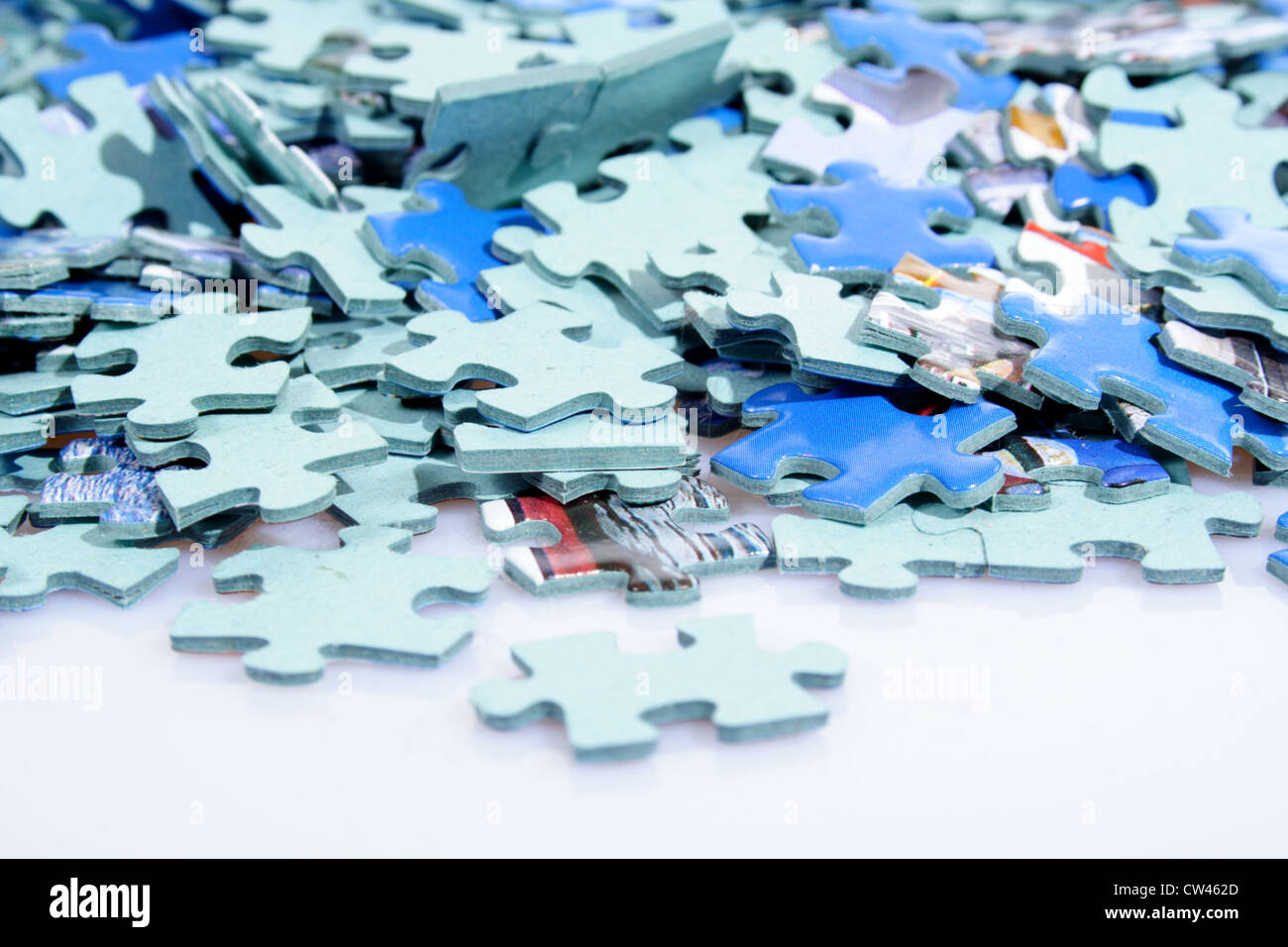 Pieces of puzzle spilled on table abstract background Stock Photo - Alamy