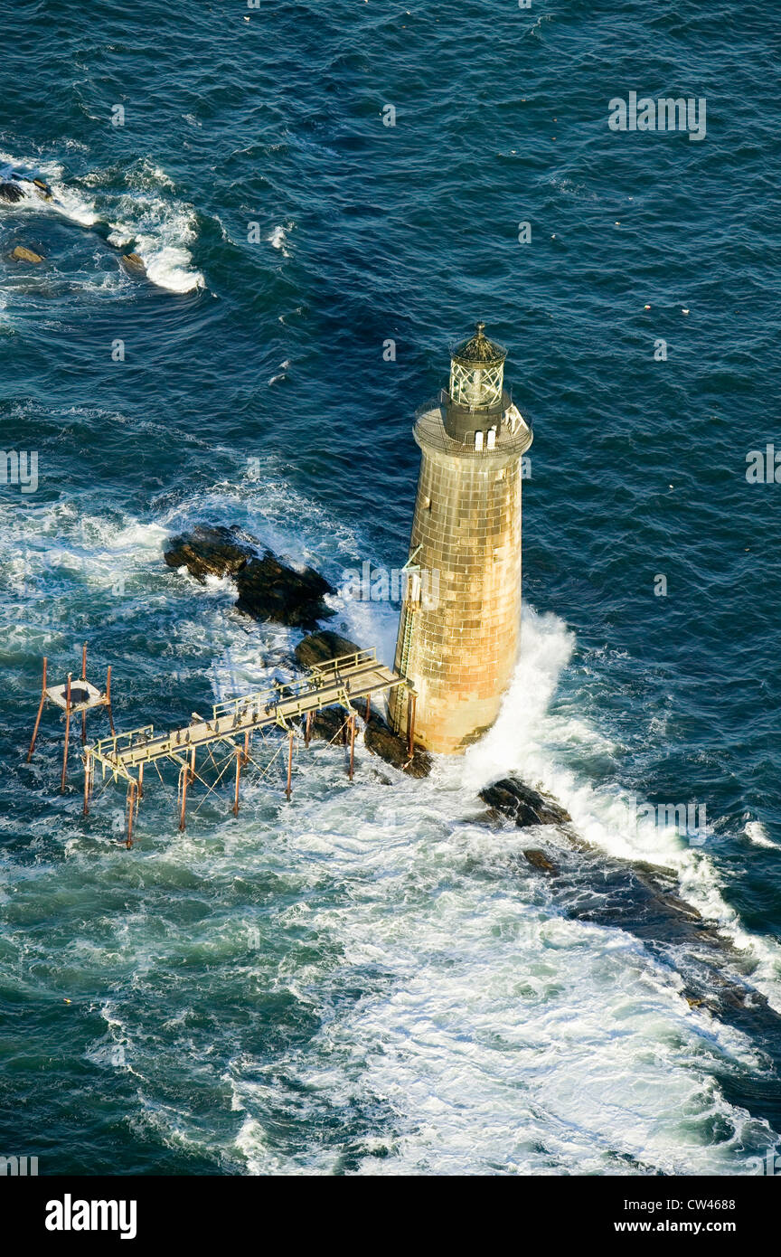 Aerial view of lighthouse at sea surrounded by water on Maine coastline ...