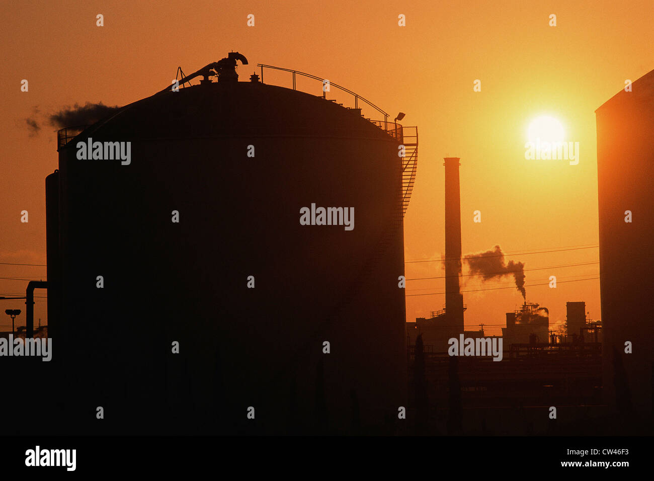 Oil refinery tank at sunset Stock Photo - Alamy
