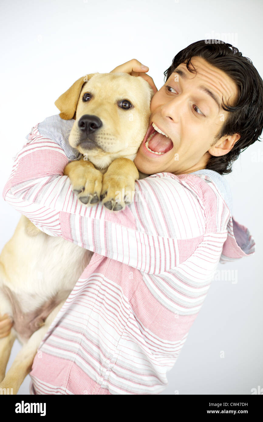 happy young male model hugging puppy labrador dog Stock Photo - Alamy