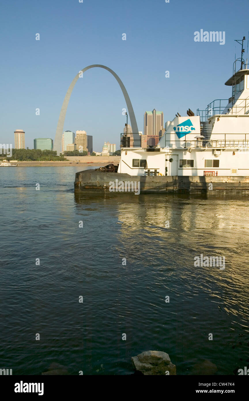 Daytime view tug boat pushing barge down Mississippi River in front ...