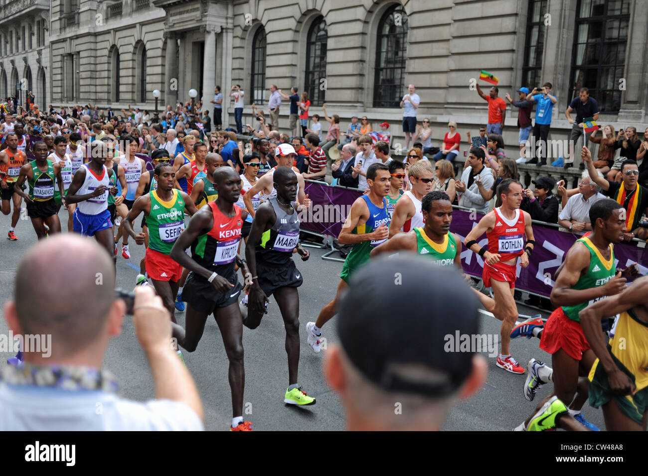 Crowds waving union jack flags during the London Olympic Marathon Mens ...