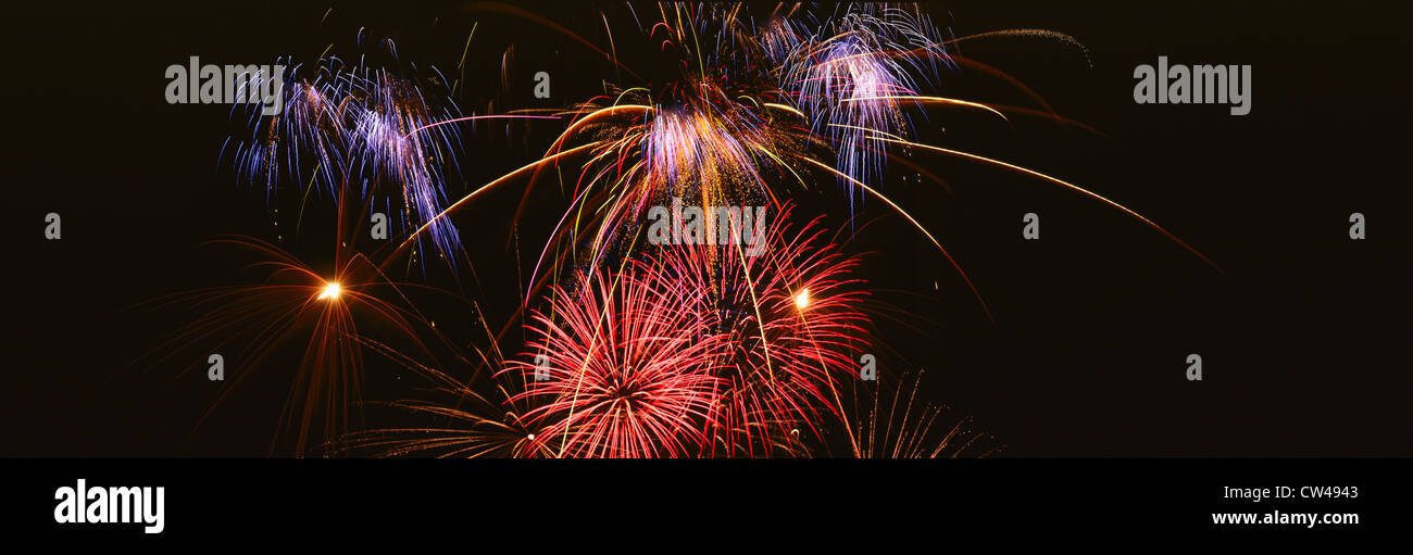 Fireworks exploding against night sky Stock Photo - Alamy