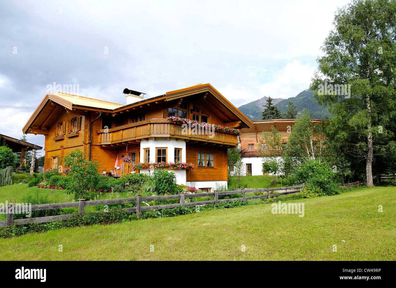 Traditional Austrian timber built building with flower boxes over ...