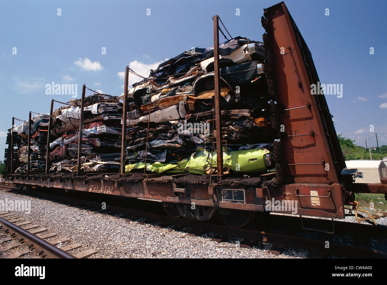 Junked smashed cars on railroad car Stock Photo - Alamy