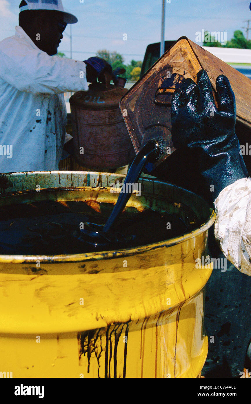 Waste oil being poured into barrel Stock Photo - Alamy