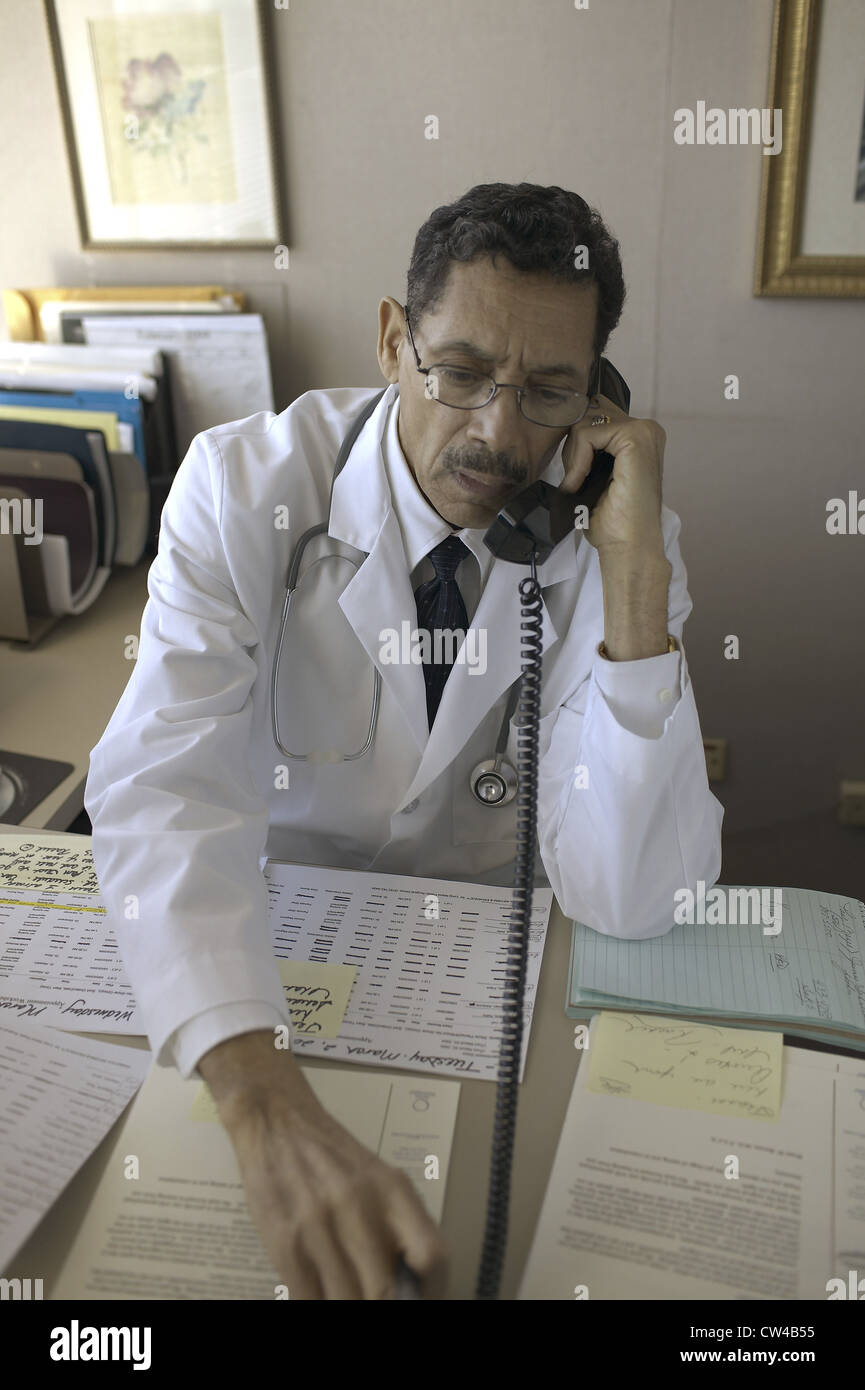 Male doctor talking on a landline telephone Stock Photo - Alamy