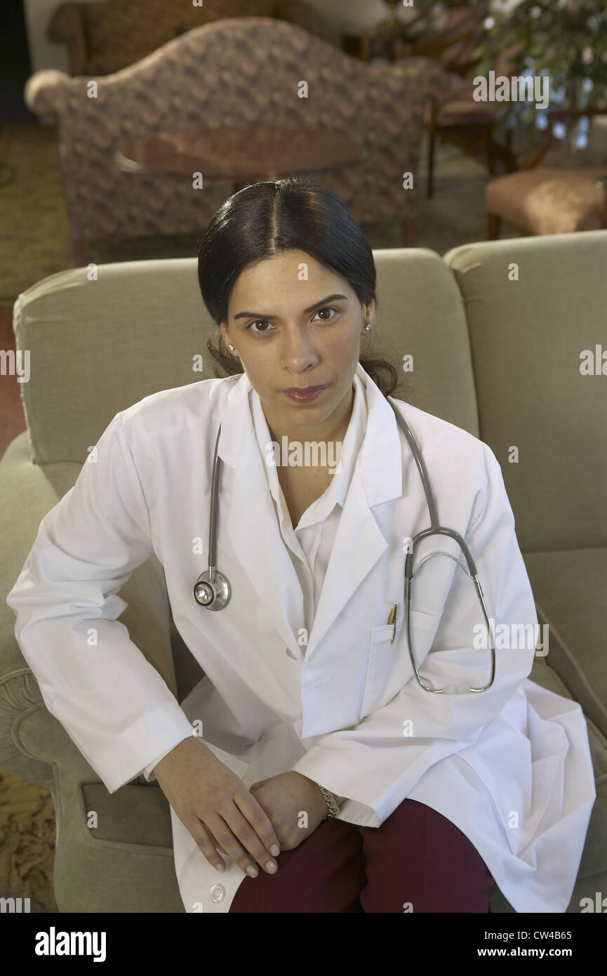 Portrait of a female doctor sitting on a couch Stock Photo - Alamy