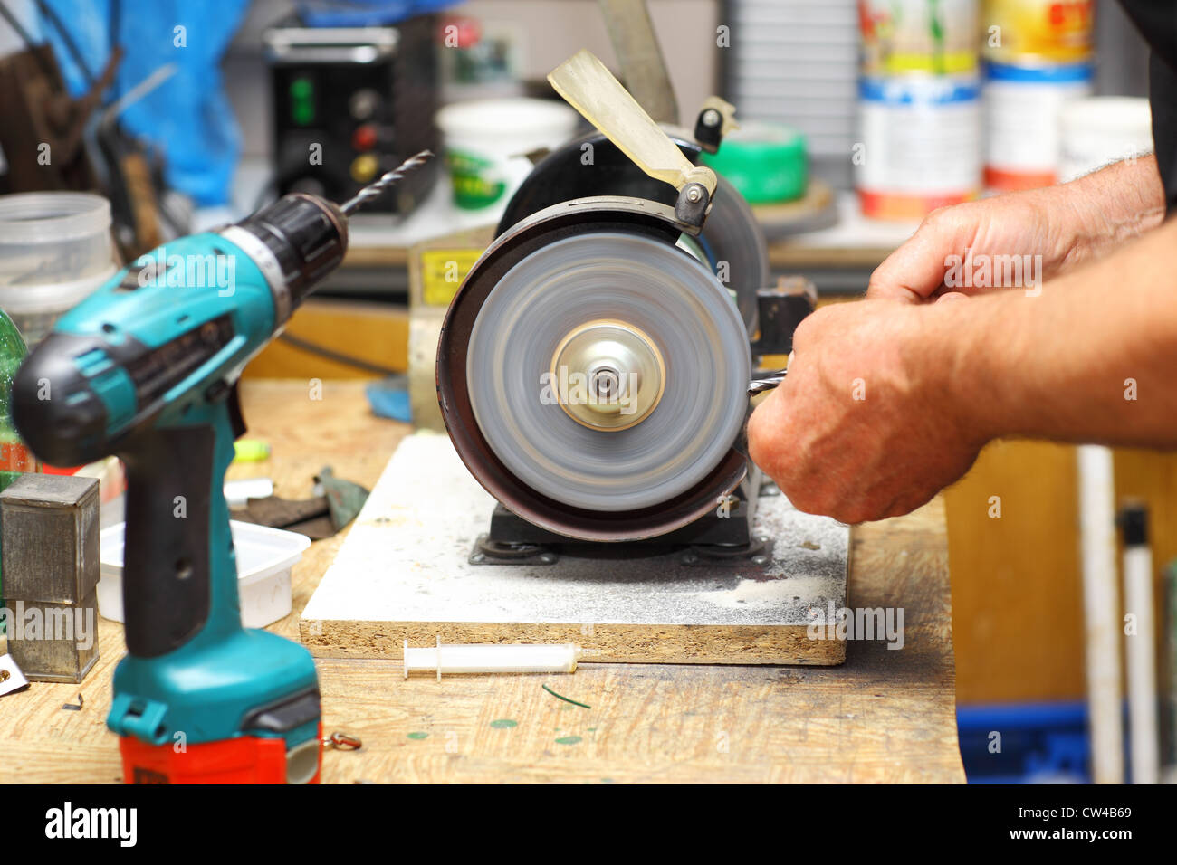 Detail of hands working on sharpening machine tool Stock Photo - Alamy