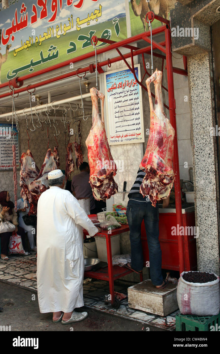 Butcher with two camel haunches in Cairo's wholesale market Stock Photo ...