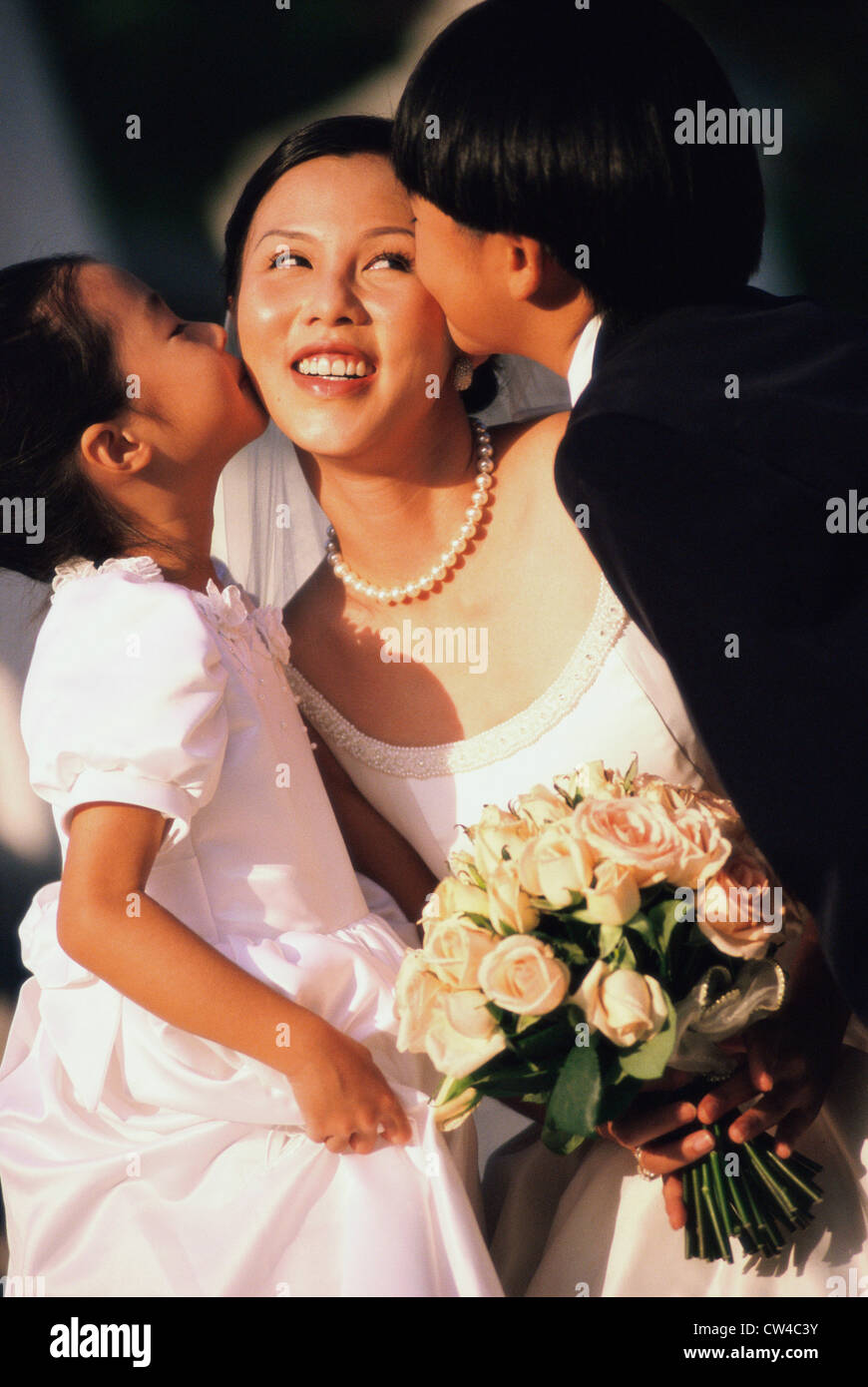 Bride kissing flower girl hi-res stock photography and images - Alamy