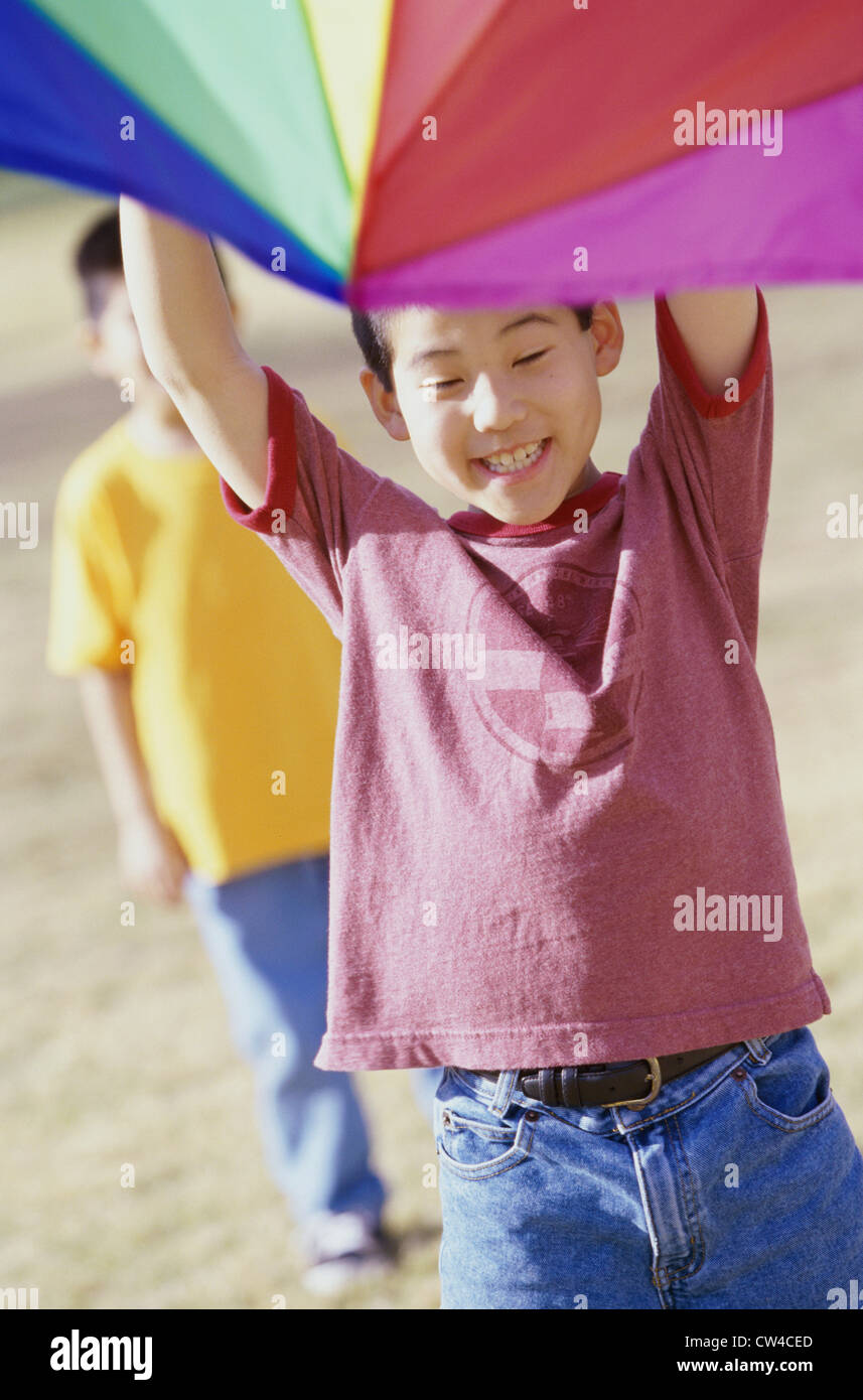 Two boys flying a kite Stock Photo - Alamy