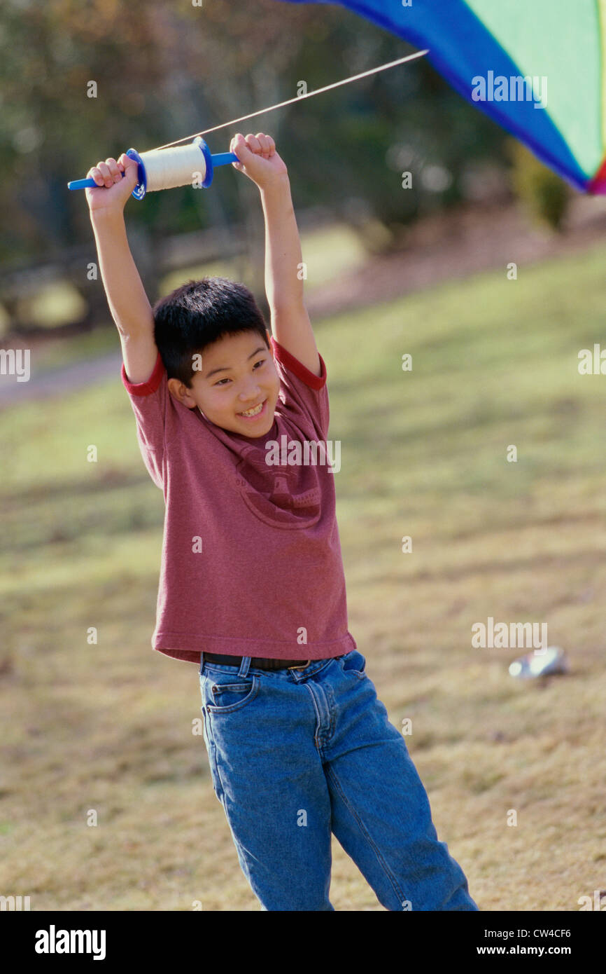 Boy flying a kite Stock Photo - Alamy