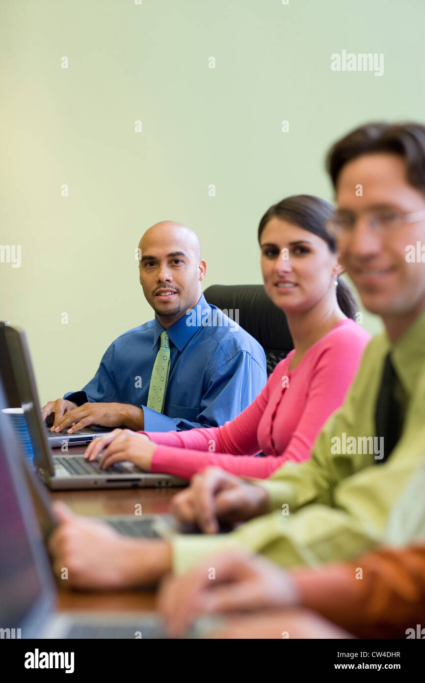 Portrait of a group of business executives sitting around a conference ...