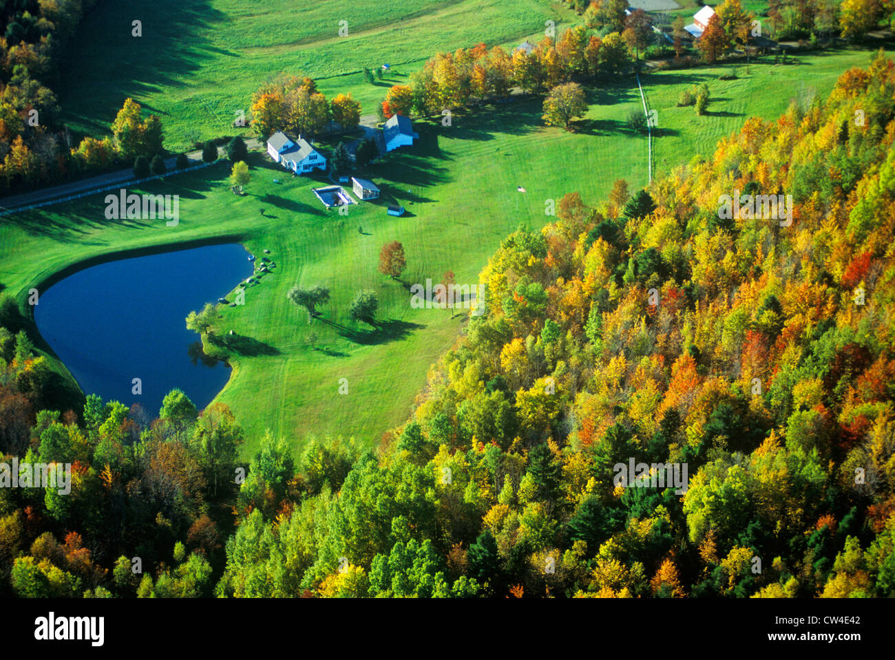 Aerial view of farm with pond near Stowe, VT in autumn on Scenic Route ...
