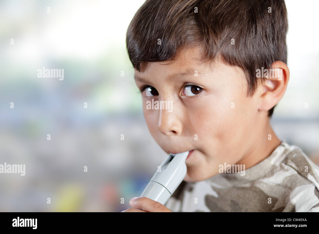 A young happy boy plays a recorder with concentration - shallow depth ...