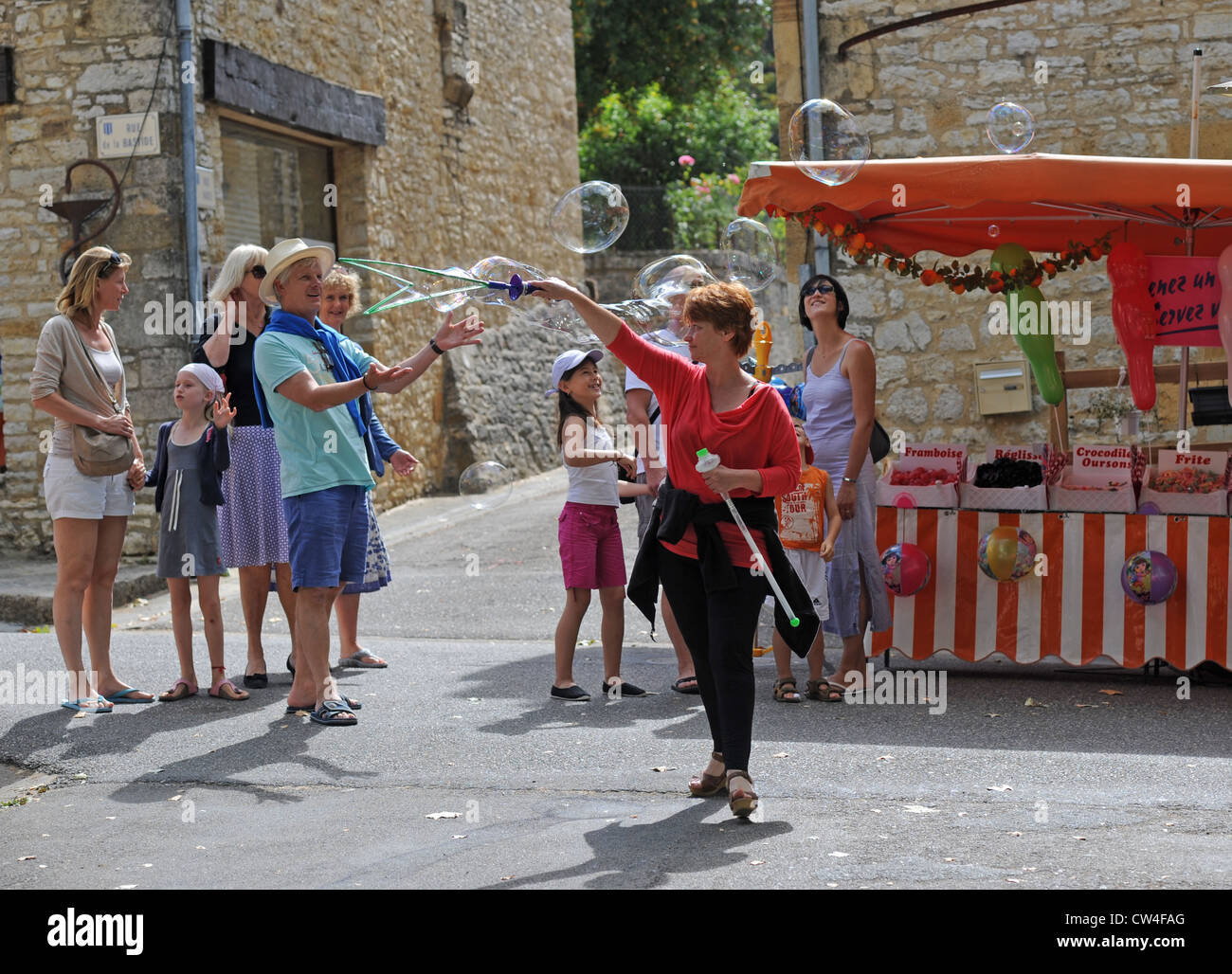 Bubble lady at the market in the village of Cazals in the Lot Region of ...