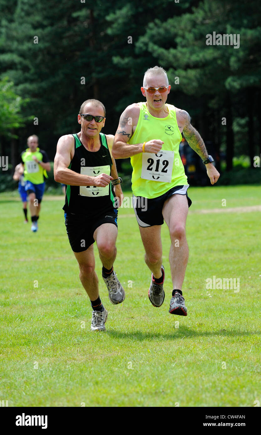Two male runners dashing for the finish line Stock Photo - Alamy