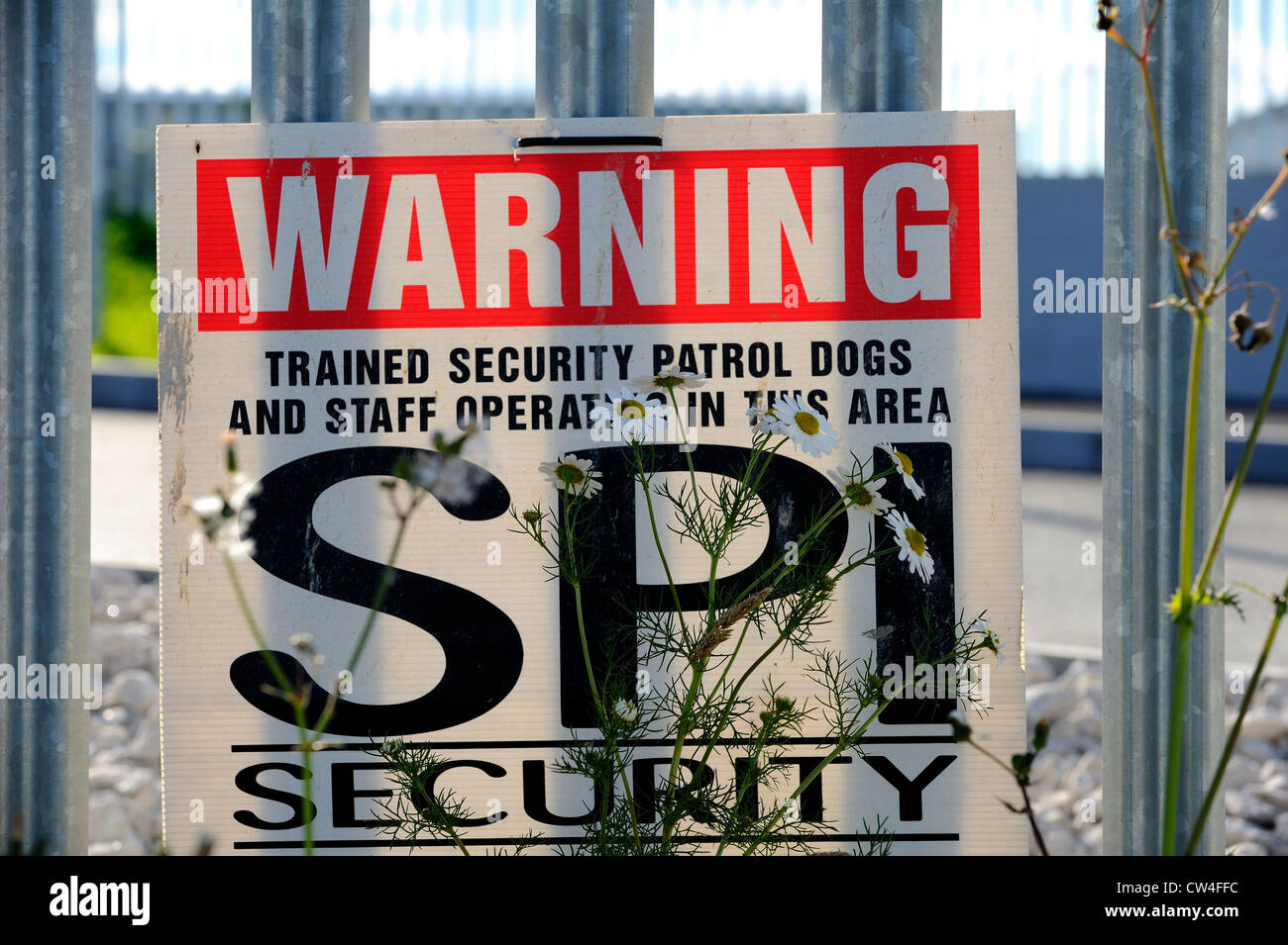 Plastic security warning sign attached to a metal railing Stock Photo ...