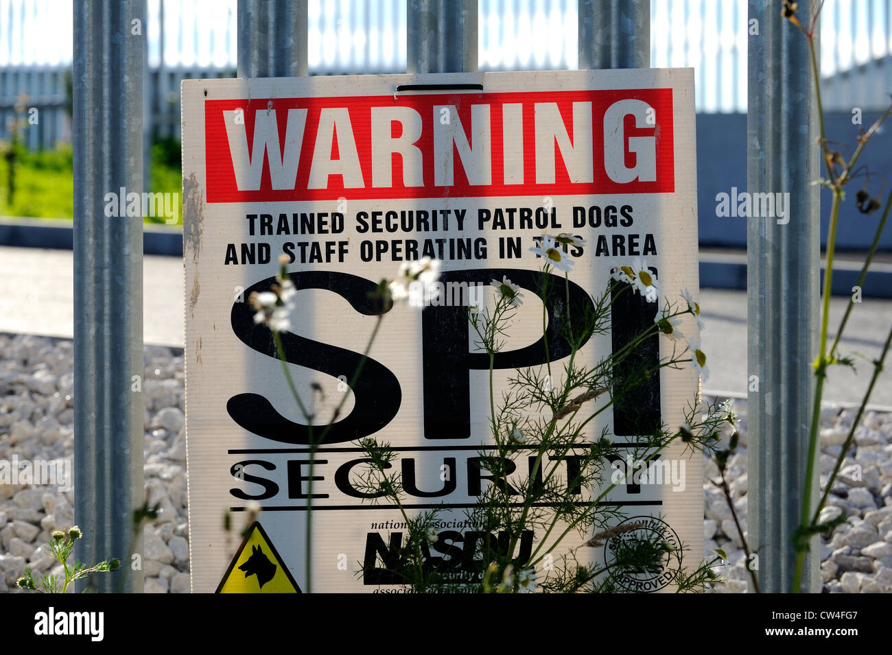 Plastic security warning sign attached to a metal railing Stock Photo ...