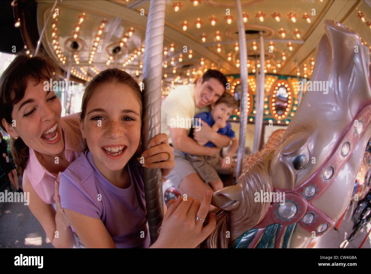 Women riding on carousel hi-res stock photography and images - Alamy