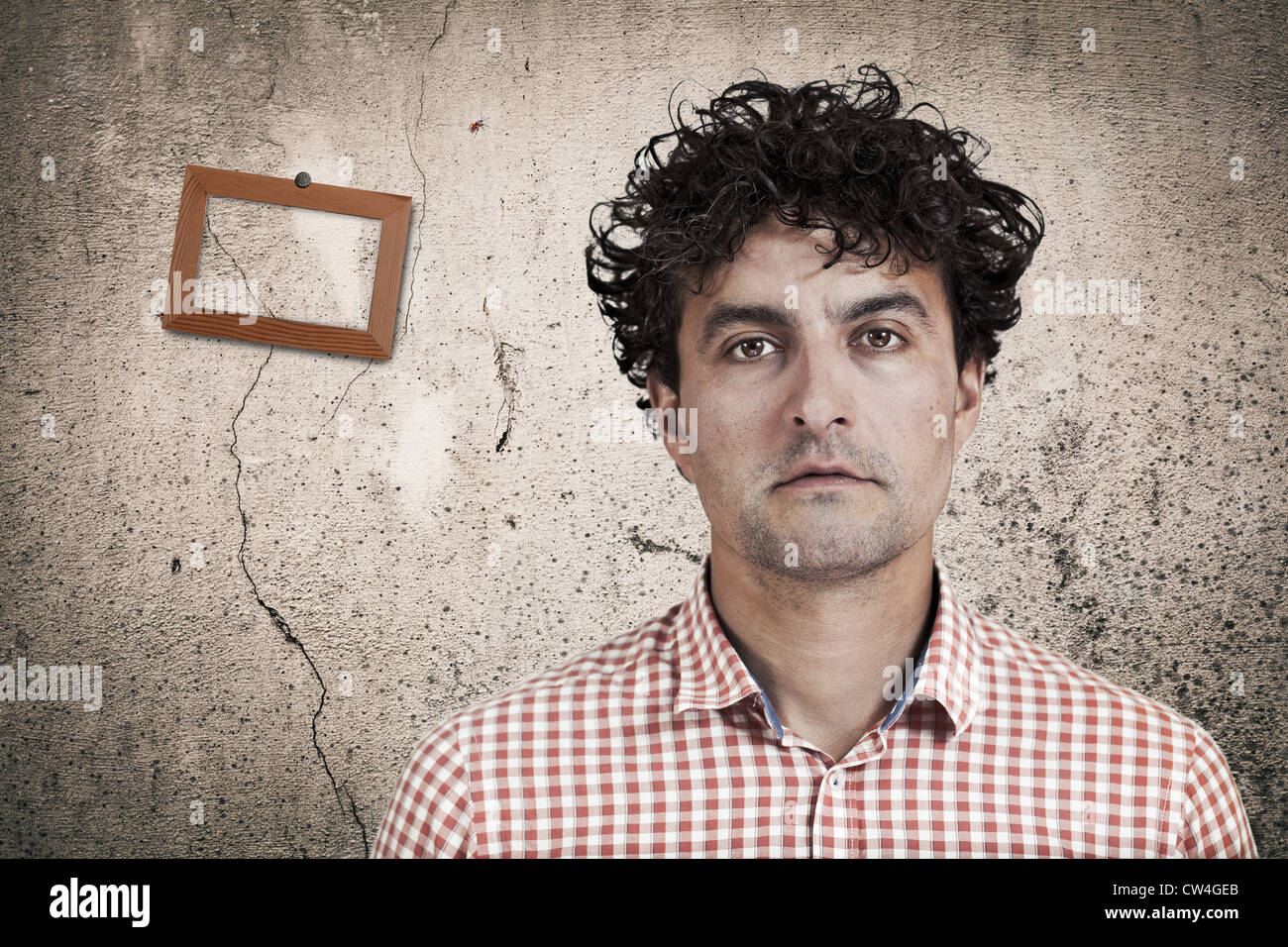 Man and old wall background with a frame Stock Photo - Alamy