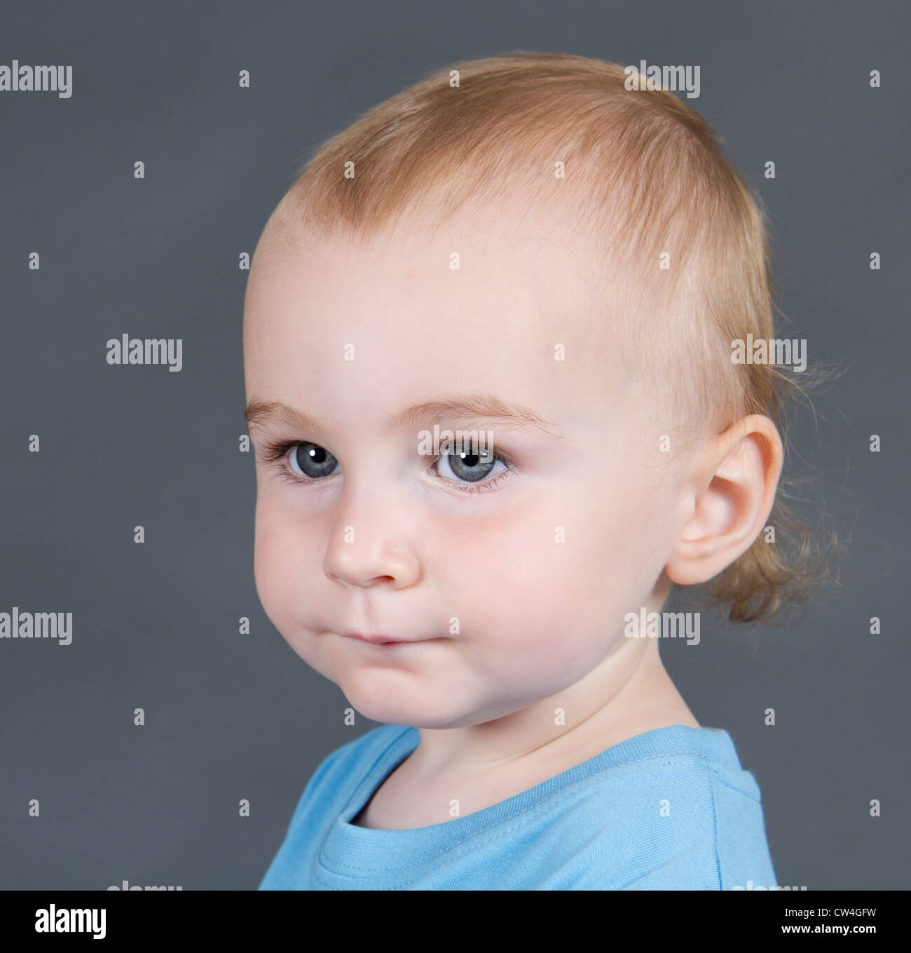 portrait of young child on grey background Stock Photo - Alamy