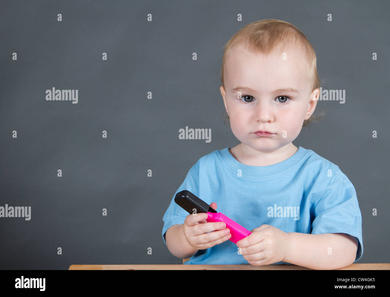 young child with highlighter in grey background Stock Photo - Alamy