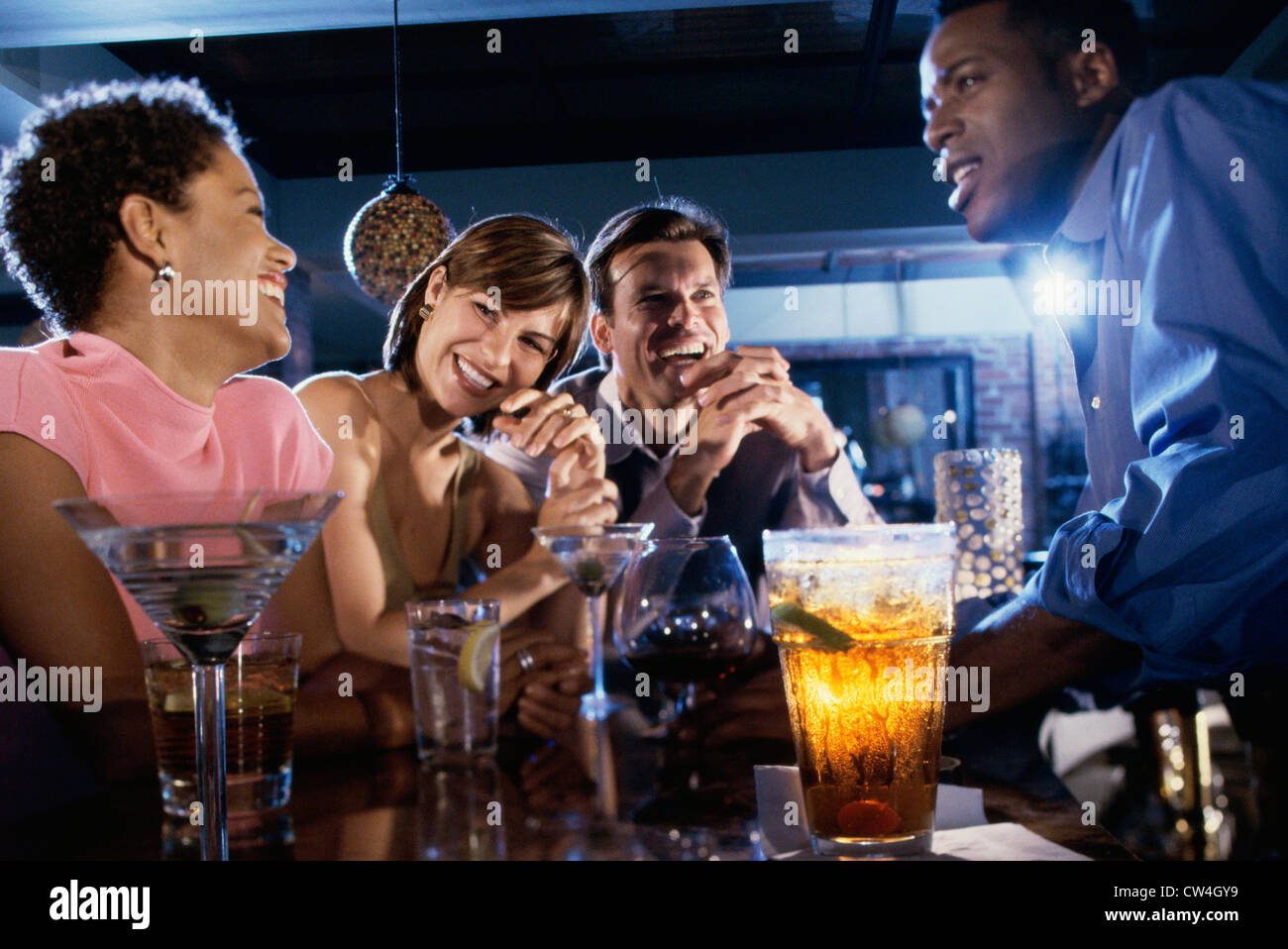 Two young couples together in a bar Stock Photo - Alamy