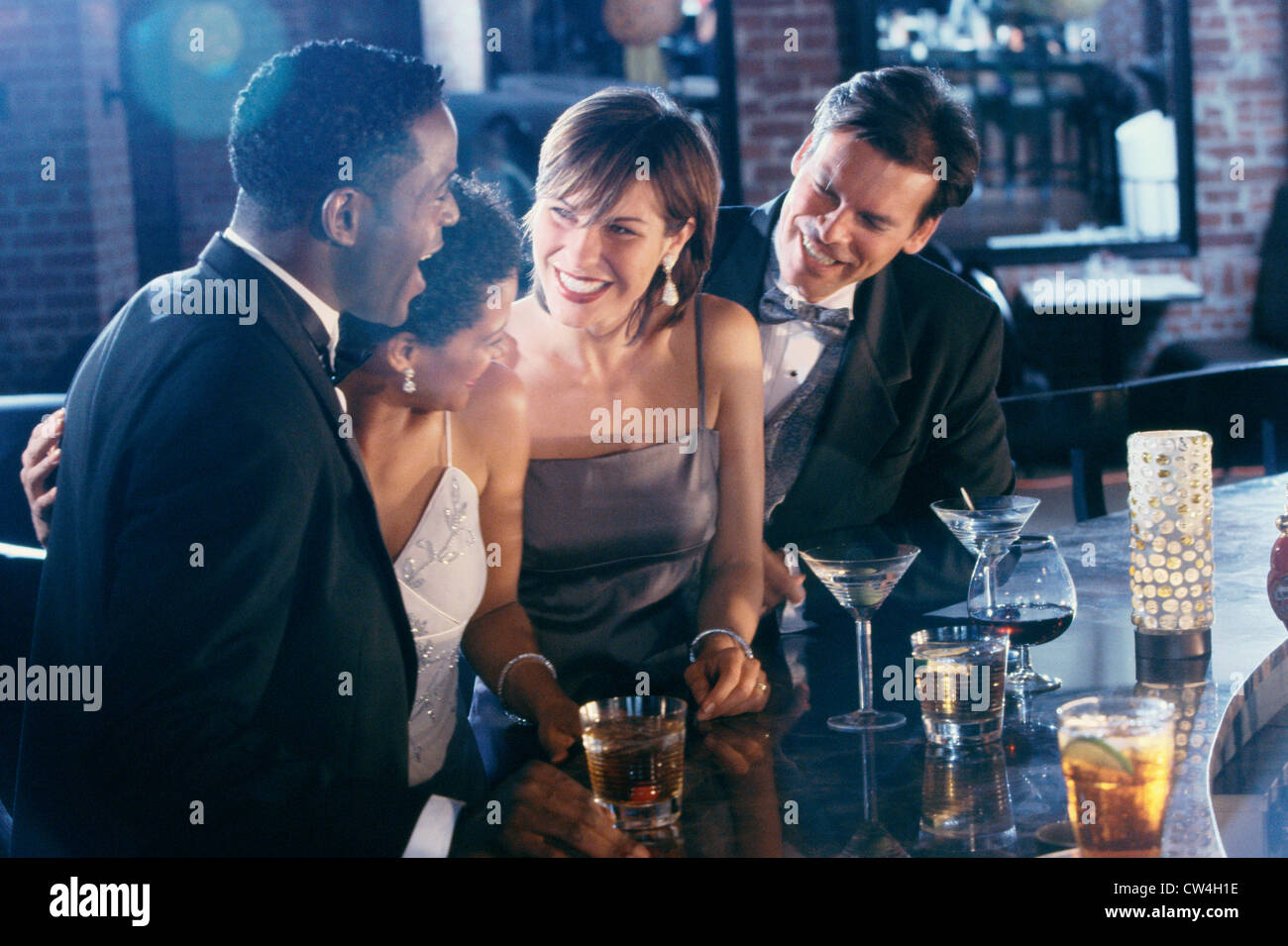 Two young couples together in a bar Stock Photo - Alamy