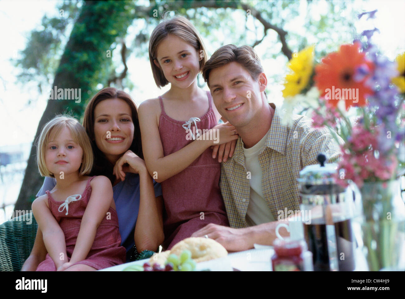 Portrait of parents with their two daughters smiling Stock Photo - Alamy