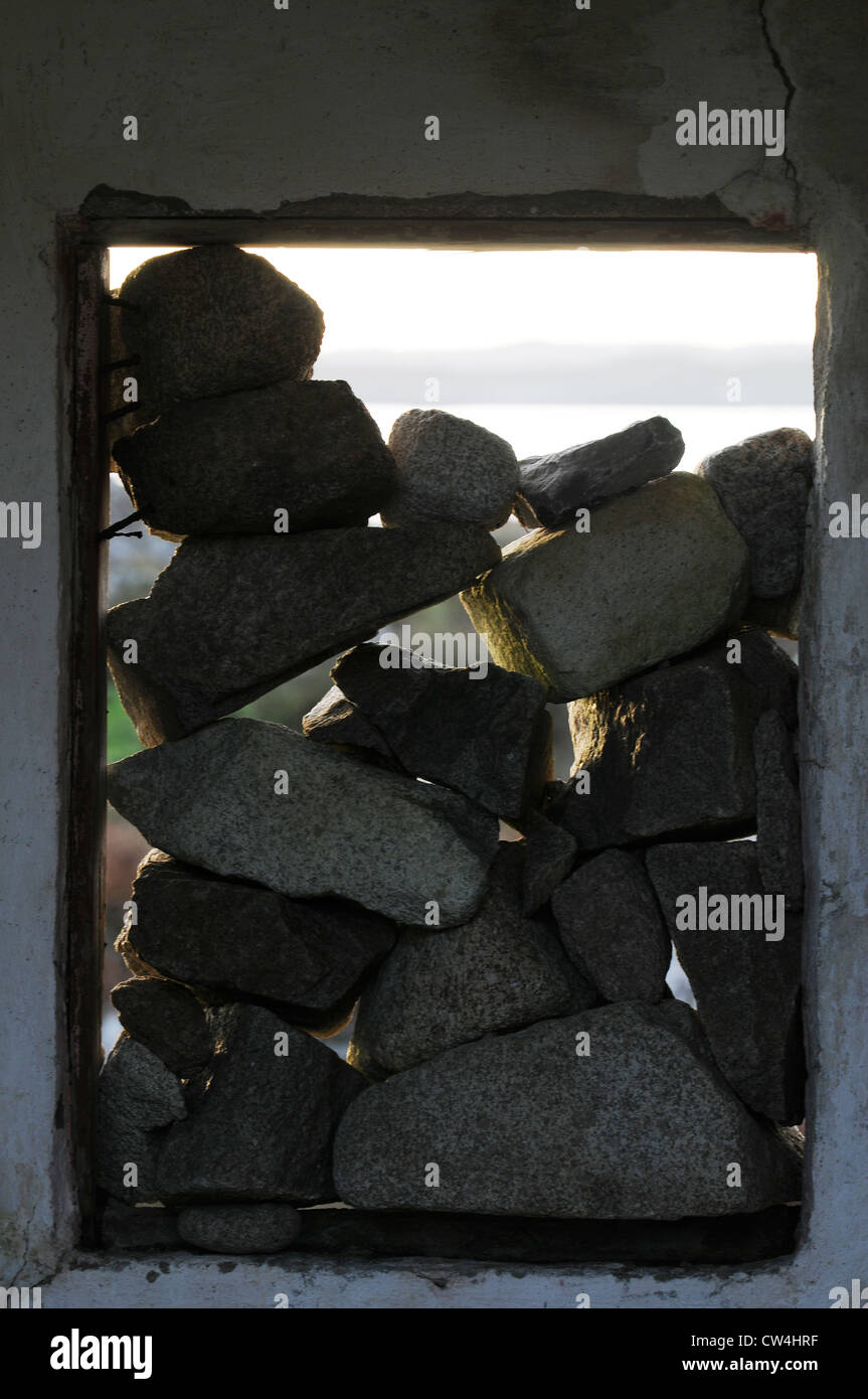 A window of a derelict house blocked with stones, Carraroe, Conamara ...