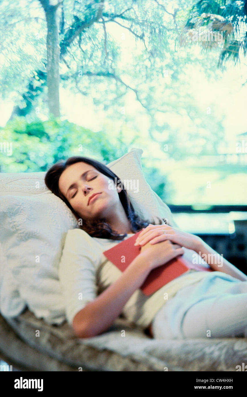 Woman holding book to chest hi-res stock photography and images - Alamy