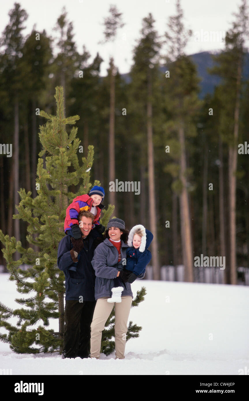 Parents with their son and daughter standing in snow Stock Photo - Alamy