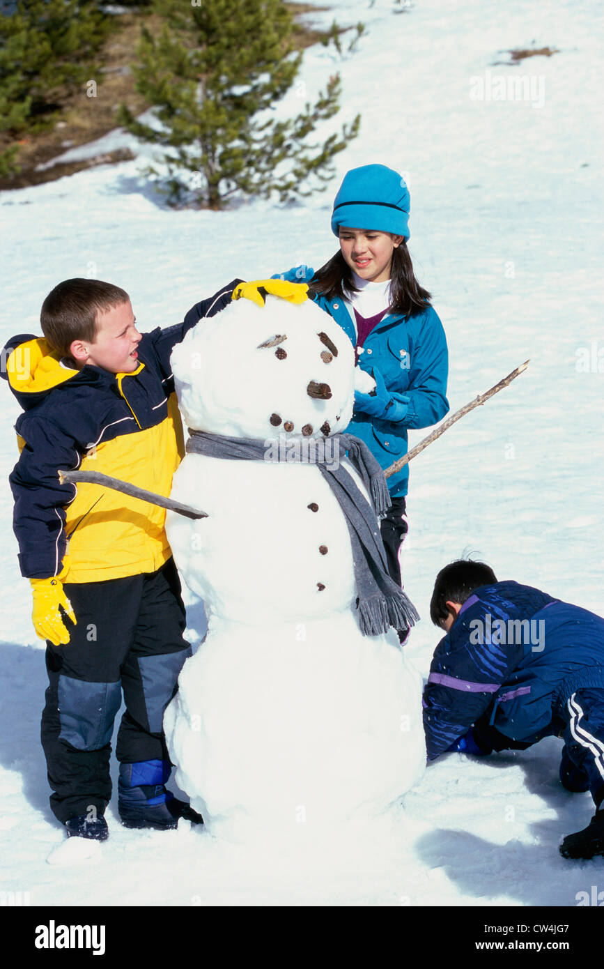Two boys making a snowman hi-res stock photography and images - Alamy