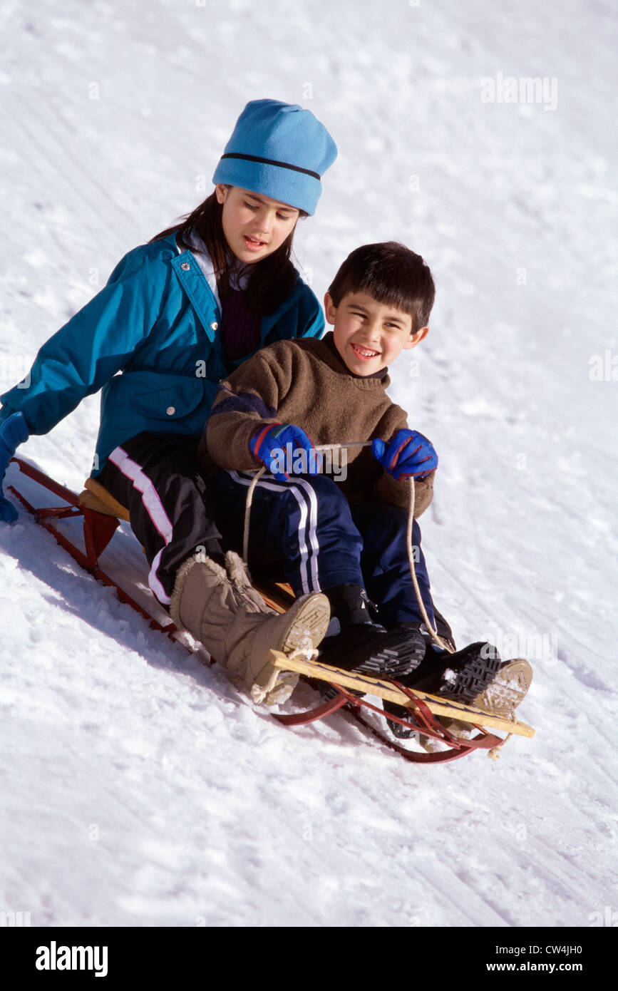 Boy and a girl riding a sled Stock Photo, Royalty Free Image: 49889532 ...