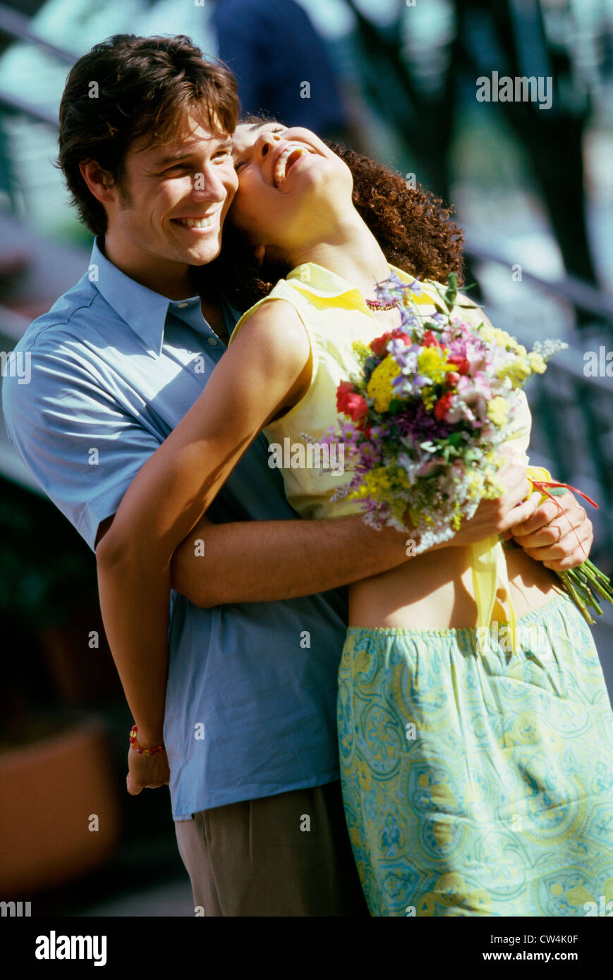 Teenage boy embracing a teenage girl from behind Stock Photo - Alamy