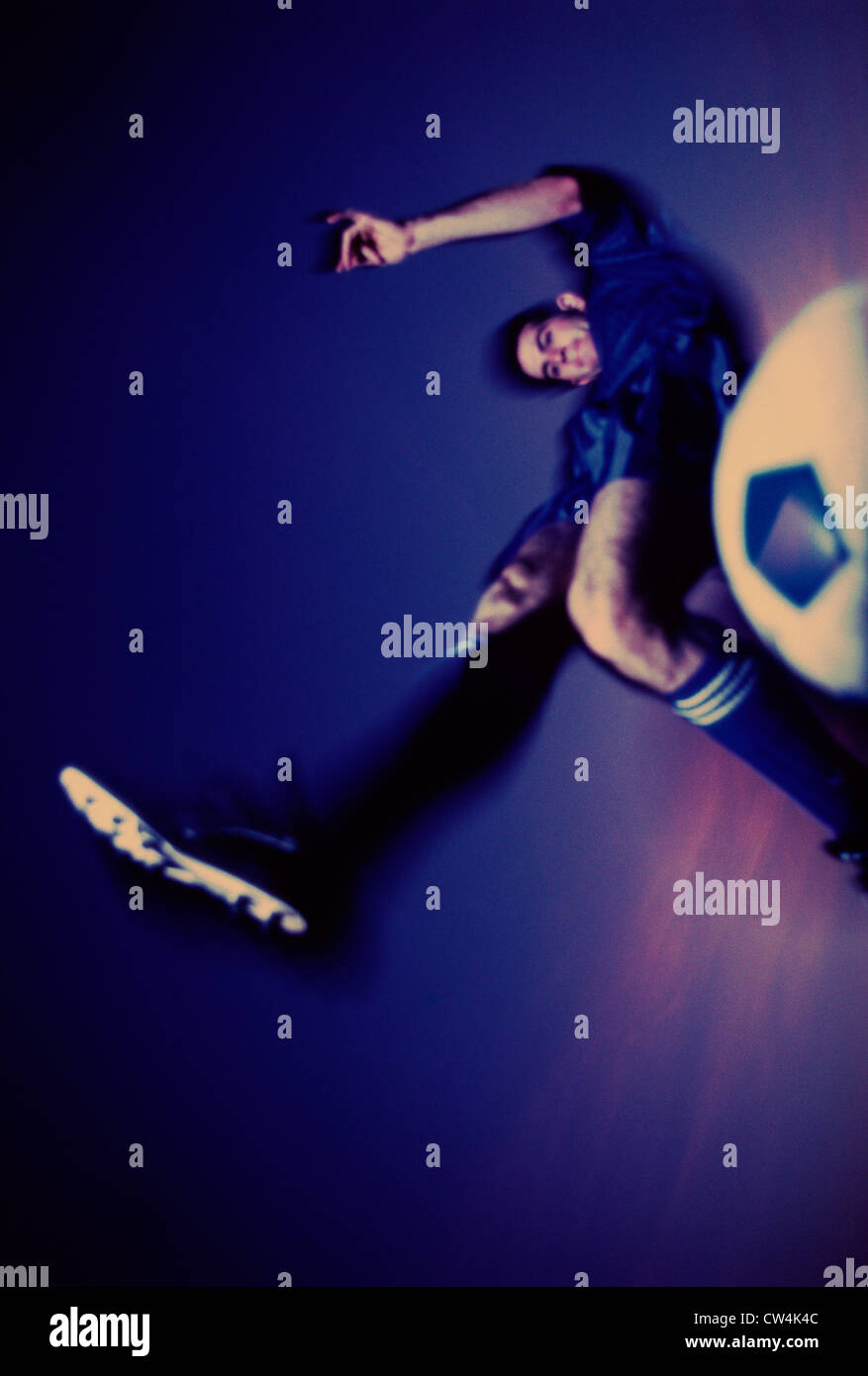 Low angle view of a soccer player kicking a soccer ball Stock Photo - Alamy