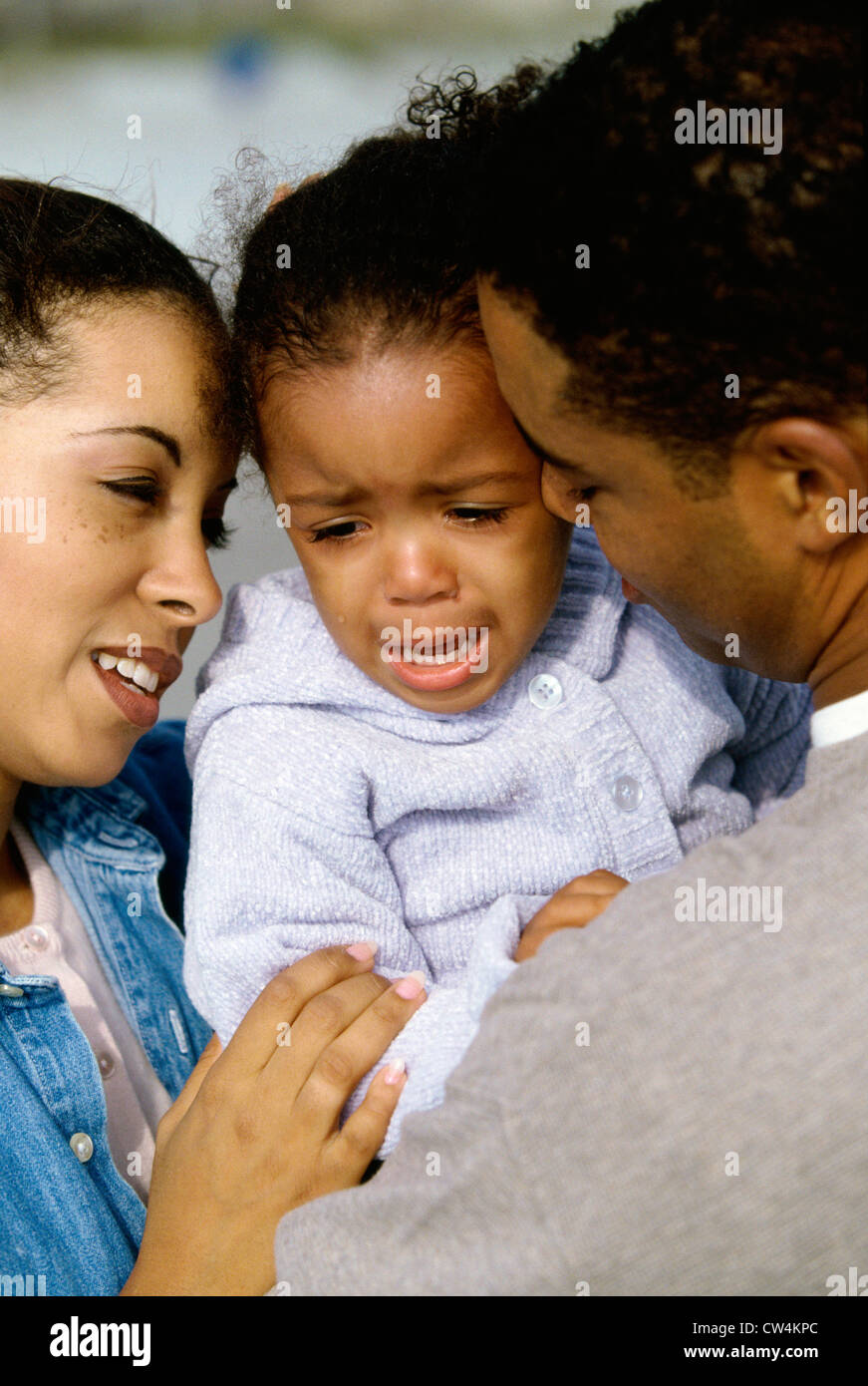 Close-up of parents consoling their crying daughter Stock Photo - Alamy
